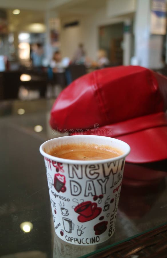 Vertical Image of Hot Coffee in a Paper Cup with Blurry Red Cap in the ...