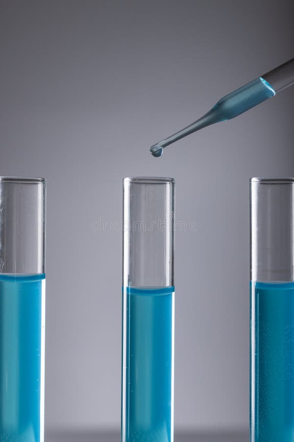 Vertical Image of Laboratory Test Tubes with Blue Liquid, Pipette and ...