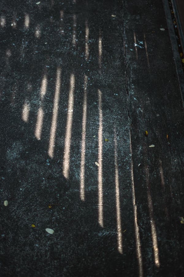 A Vertical Shot of a Railing Shadow Casted on the Ground Stock ...