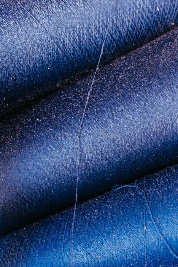 A Vertical Shot of Blue Thread Spools Stock Photo - Image of fabric ...