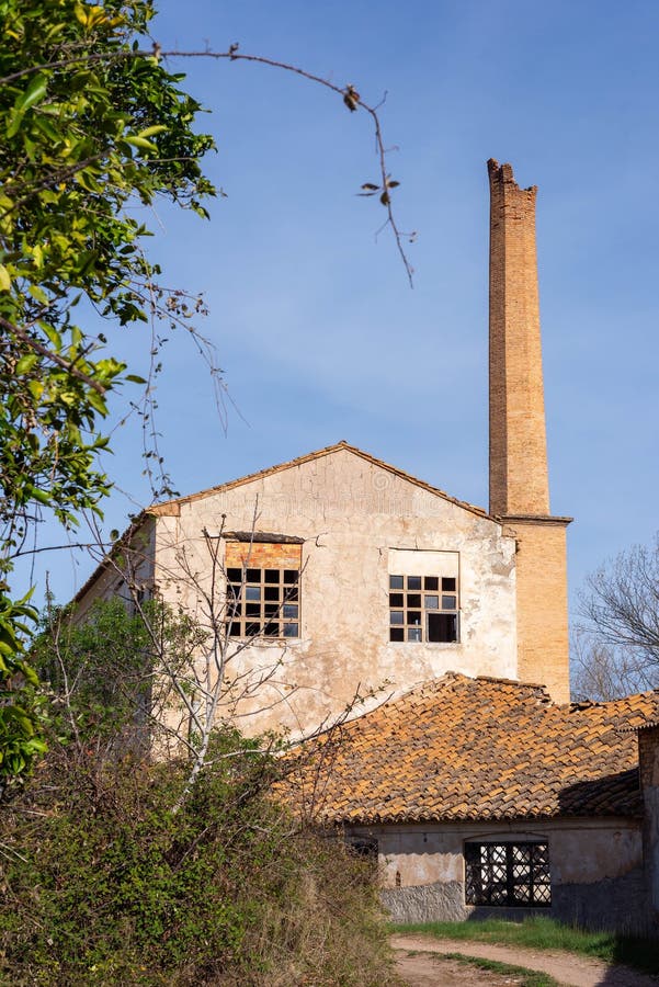 Vertical Image of an Old Abandoned Gray Paper Mill with a Brick Chimney ...