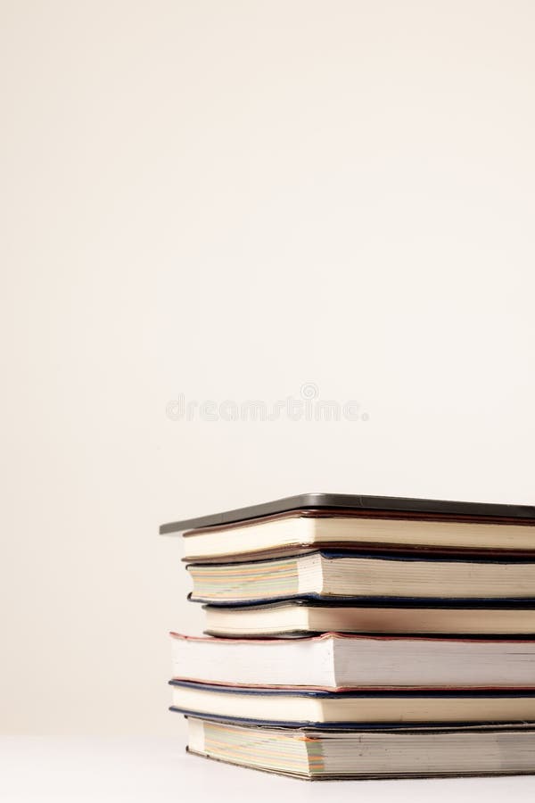 Vertical Image of Stack of Books on Beige Surface Stock Image - Image ...