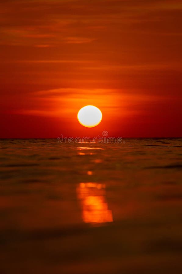 Vertical Image of a Sun Above a Water Surface during a Golden Hour ...