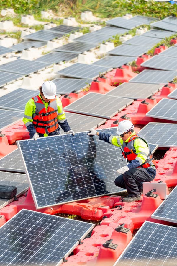 Vertical Image of Two Technician Workers Help To Set Up or Install ... Vertical Image of Two Technician Workers Help To Set Up or Install ...