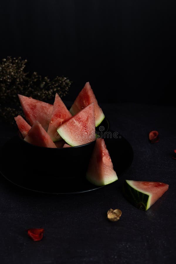Vertical Image of Watermelon Cut into Pieces Inside a Black Bowl on a ...