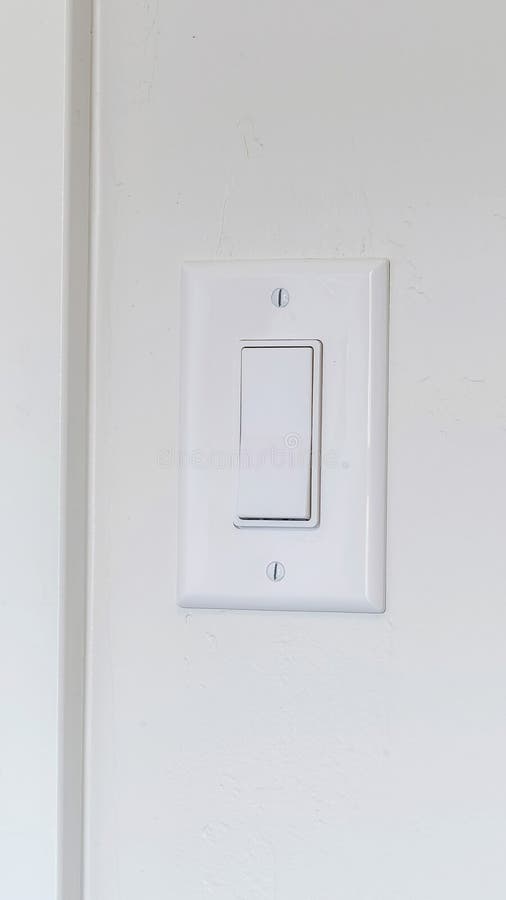 Vertical Indoor Electrical Light Switch of Home Mounted on White Wall ...