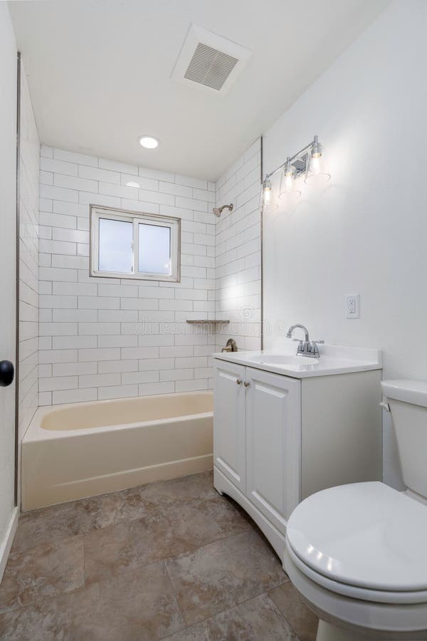 Vertical Interior View of a New, Renovated Empty White Bathroom with ...