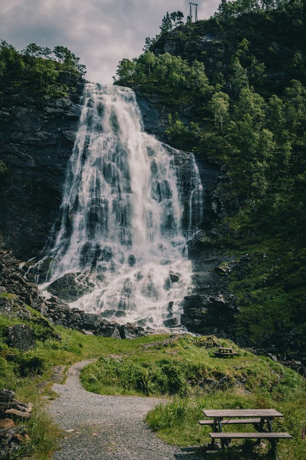 Vertical and Long Exposure Shot of a Waterfall in a Valley Emerging ...