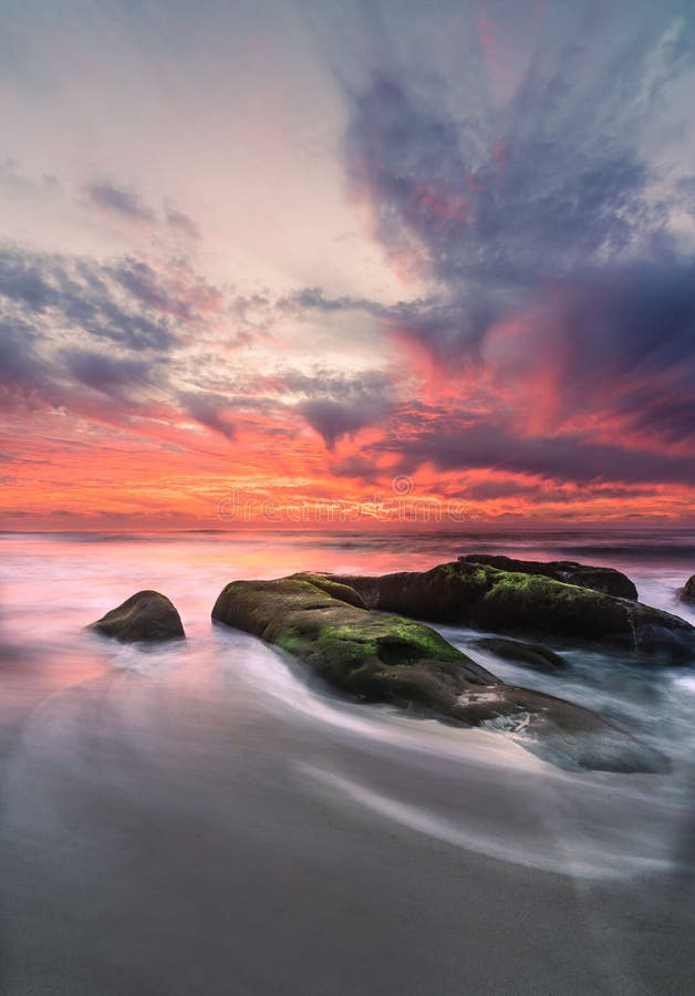 Vertical Long Exposure of Stones Under the Dramatic View of Sunset Pink ...