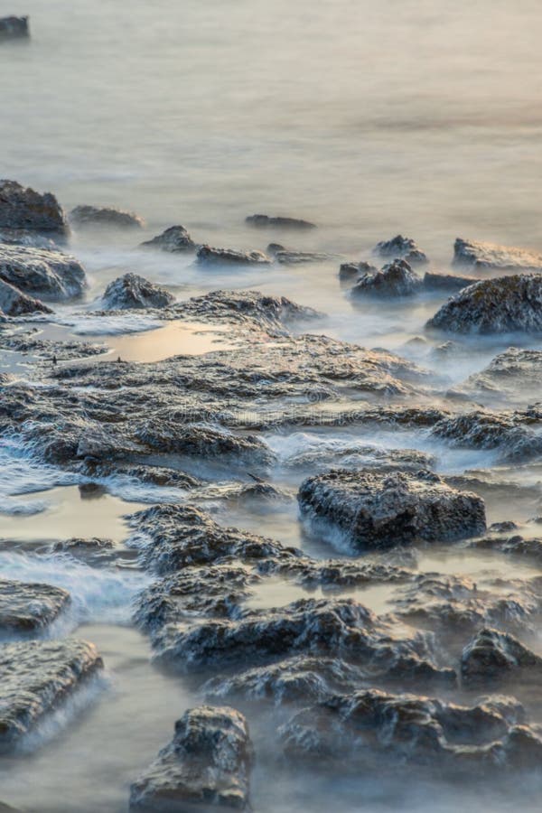Vertical Long-exposure View of Coastal Stones in the Water Stock Image ...