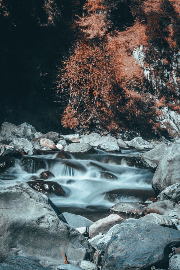 Vertical Long Exposure of Waterfall Cascades and Big Rocks Against the ...
