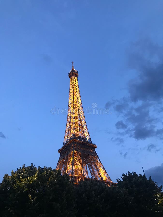 Vertical Low Angle of the Eiffel Tower with Yellow Lighting in the ... Vertical Low Angle of the Eiffel Tower with Yellow Lighting in the ...
