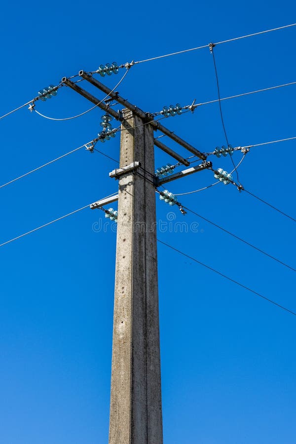 Vertical Low Angle of an Electric Post Isolated on Blue Background ...