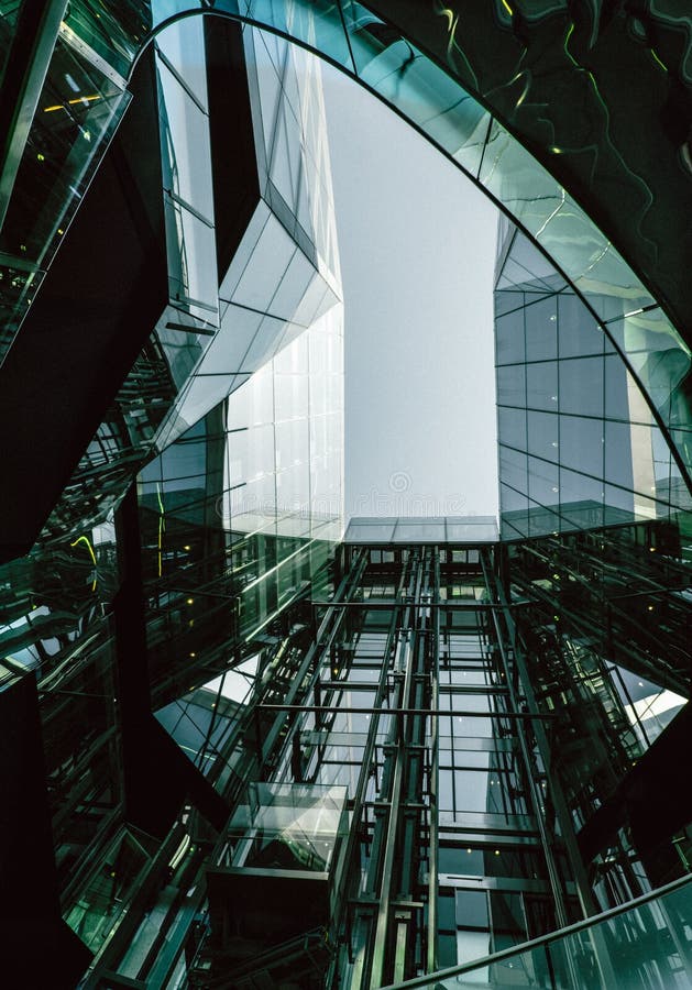 Vertical Low Angle Shot of a Beautiful Modern Glass Building Under the ...