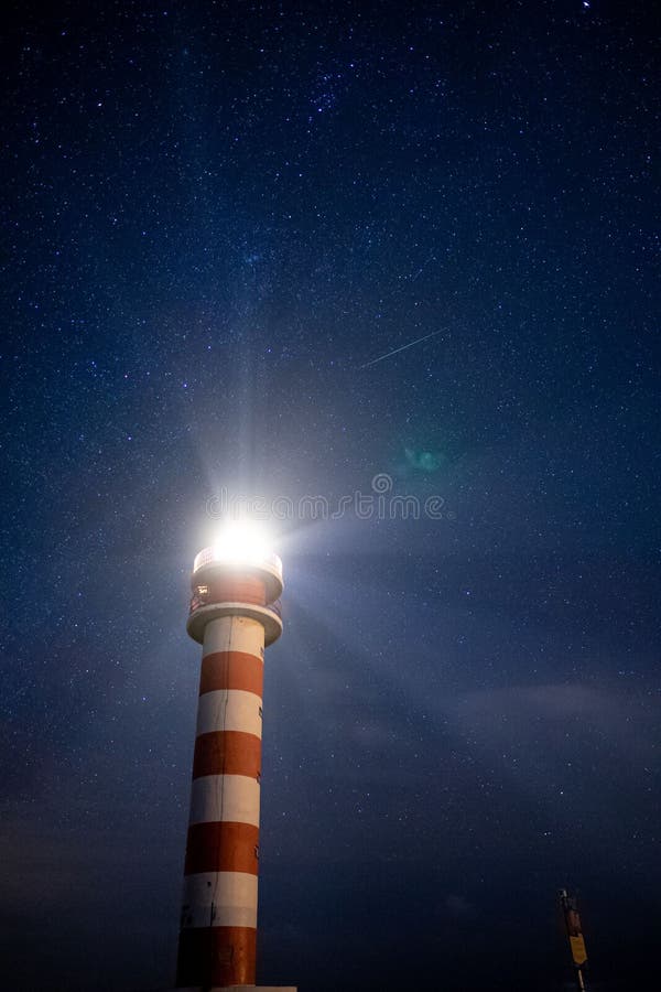 Vertical Low Angle Shot of Bright Light on the Top of Lighthouse ...