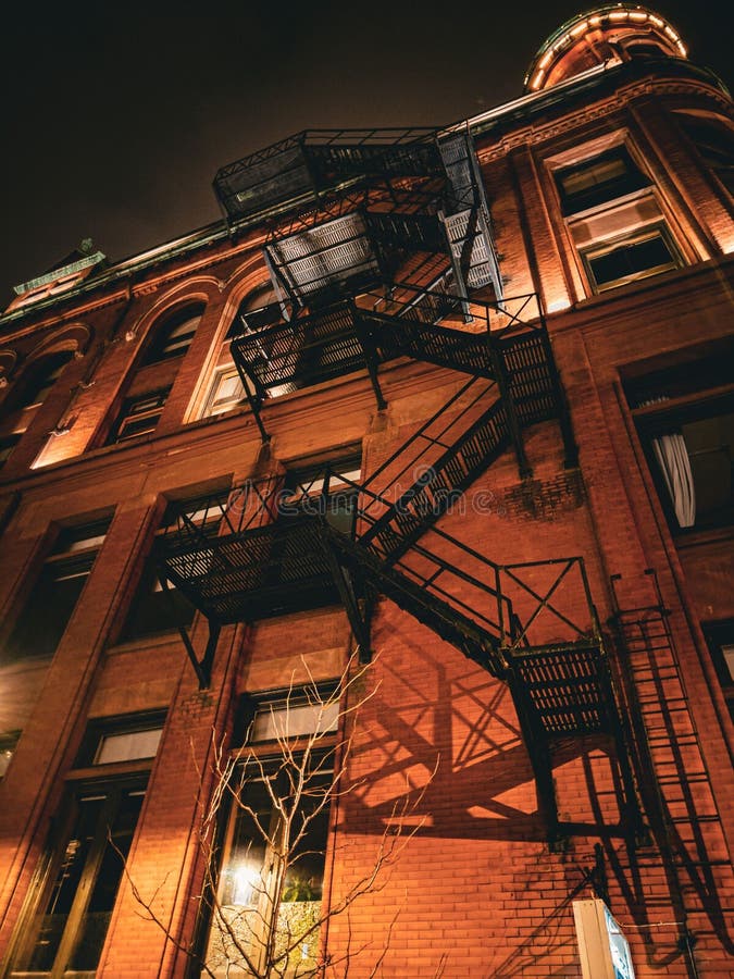 Vertical Low-angle Shot of a Building with a Fire Escape at Night ...