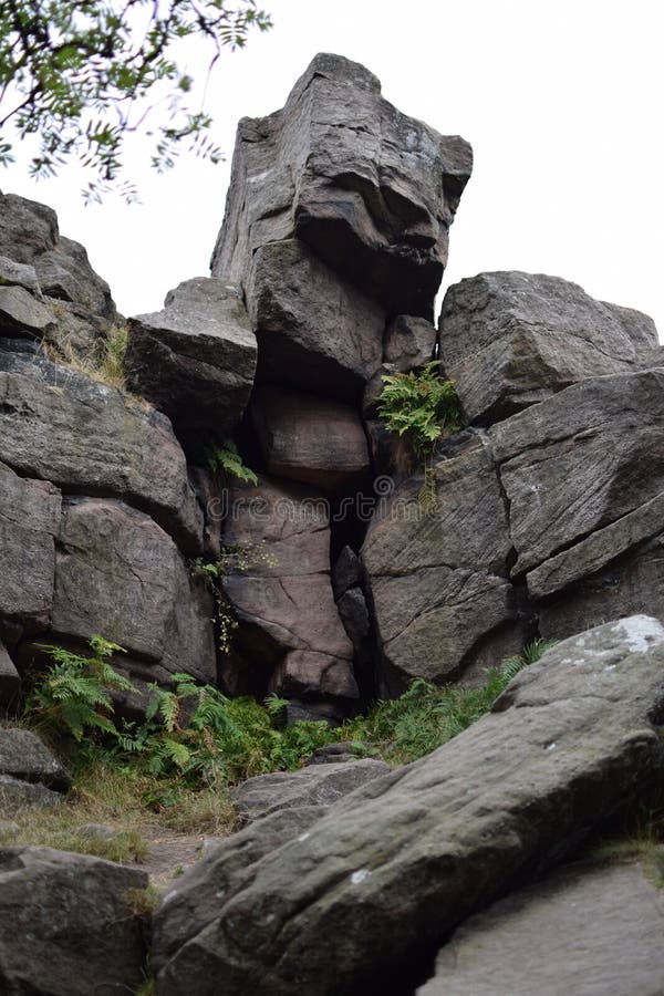 Vertical Low-angle Shot of a Hanging Stone with Sky in the Background ...