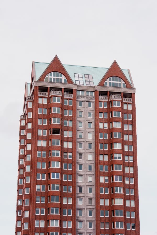 Vertical Low Angle Shot of a High-rise Red Building on a White ...