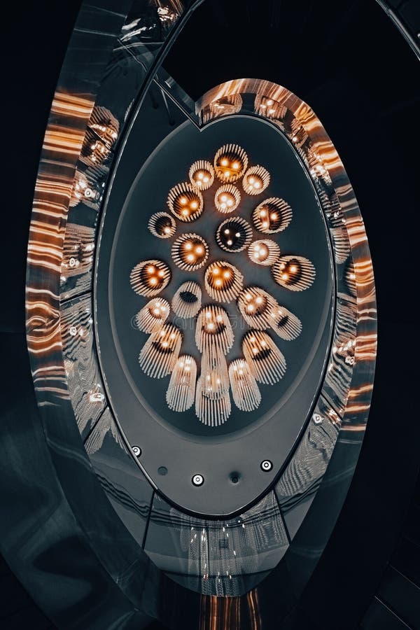 Vertical Low Angle Shot of Multiple Illuminated Chandeliers Hanging ...