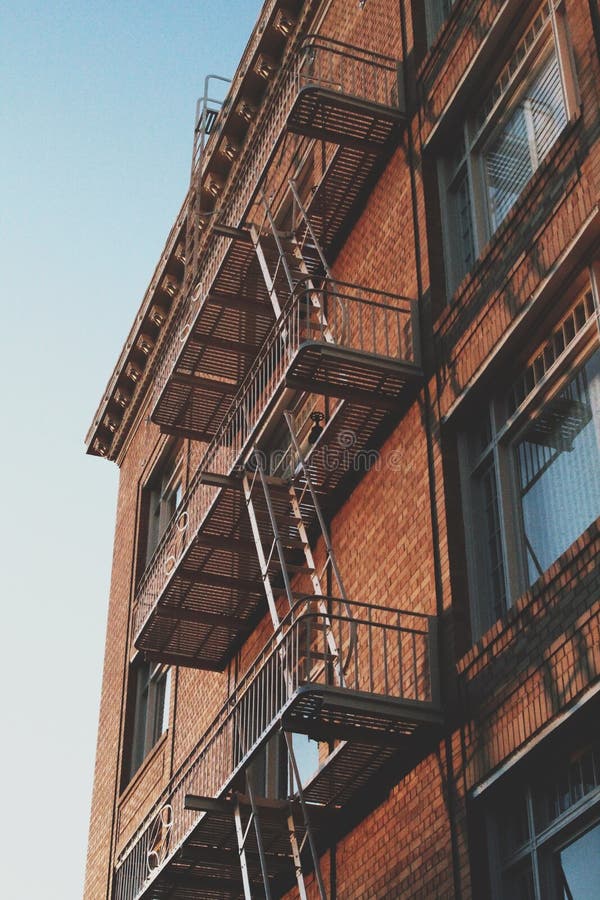 Vertical Low-angle Shot of an Old Brick Building with the Emergency ...
