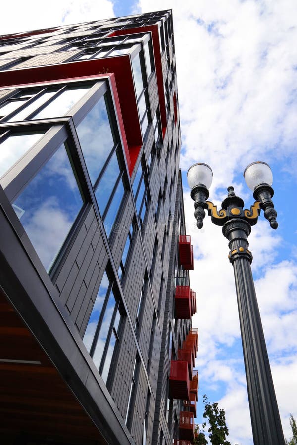Vertical Low Angle Shot of a Street Light Next To a Modern Building ...