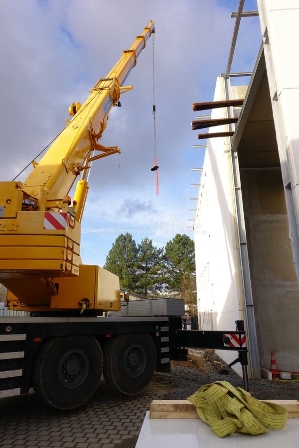 Vertical Low Angle Shot of a Tall Mobile Crane on a Construction Site ...
