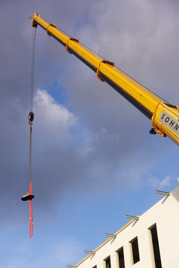 Vertical Low Angle Shot of a Tall Mobile Crane on a Construction Site ...