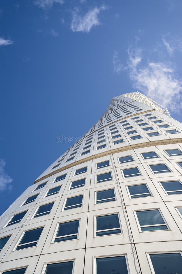 Vertical Low Angle Shot of a Tall Twisting Building on a Blue Sky ...