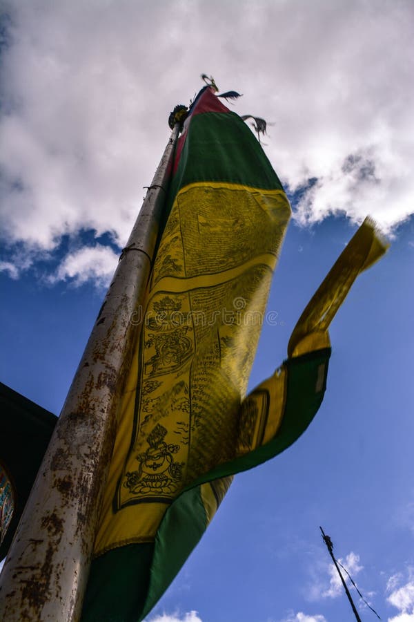 Vertical Low Angle Shot of a Waving Buddhist Darchog Prayer Flag Under ...