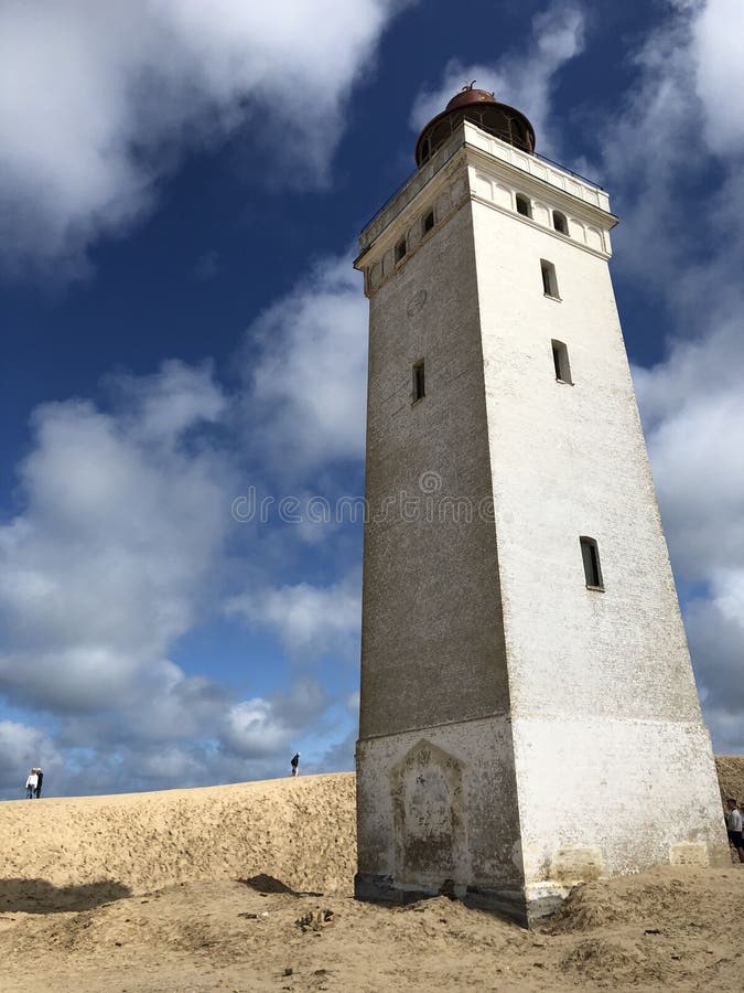 Vertical Low Angle of a Stone Lighthouse Tower Against a Cloudy Sky ...