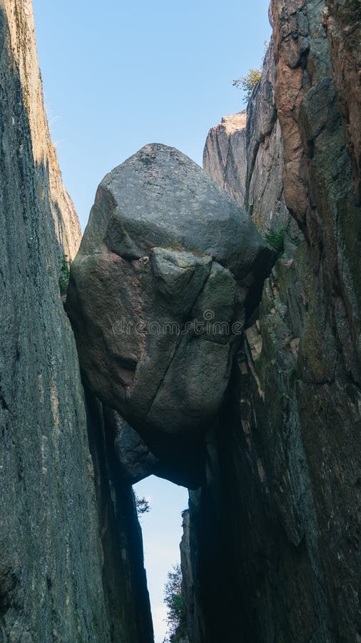 Vertical Low Angle View of a Big Stone Stuck in between Two Cliffs ...