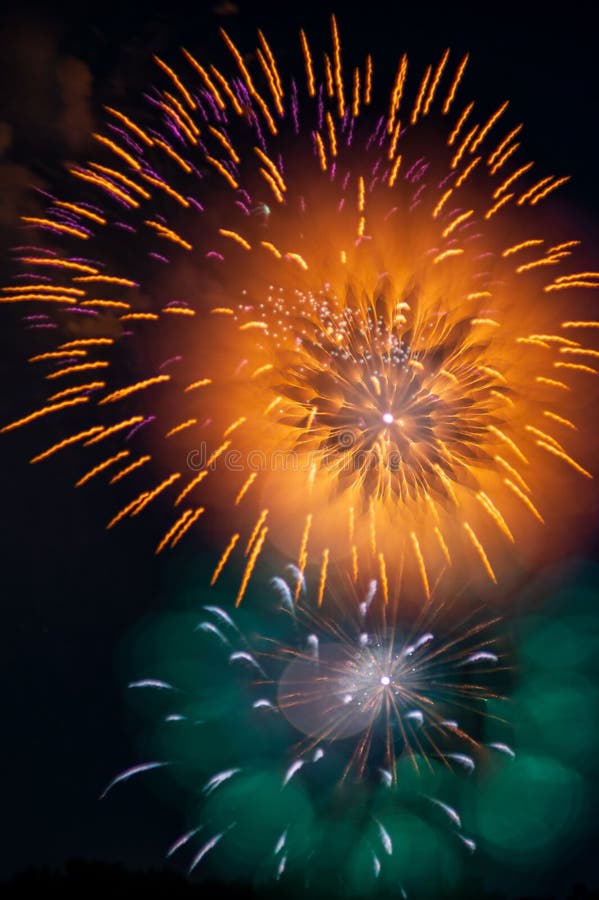 Vertical Low Angle View of a Colorful Fireworks Exploding in a Night ...