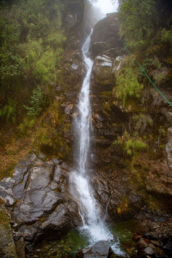 Vertical Low-angle of a Waterfall Flowing among Stone Mountains, Grass ...