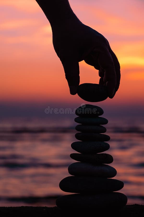 Vertical ?mage of Stacking Rocks on the Beach with a Sunset Ocean Stock ...