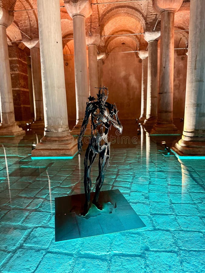 Vertical of a Man S Statue and Columns Reflected in Water in the ...