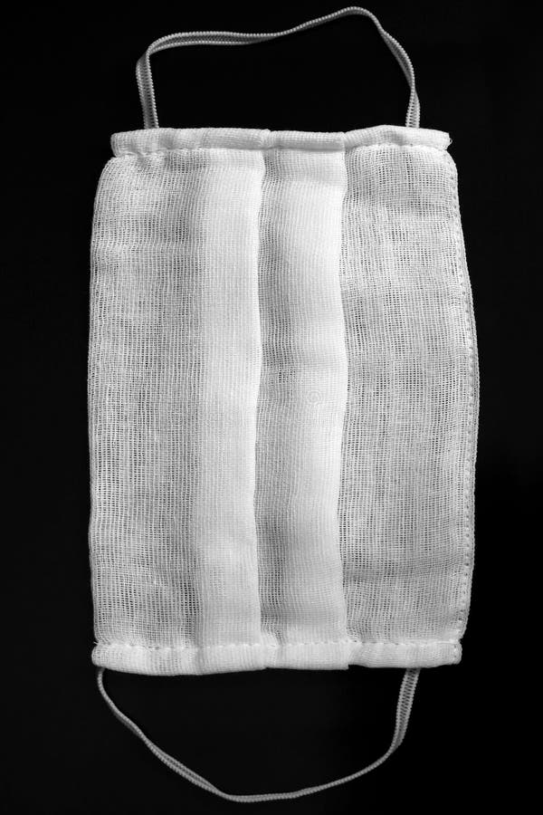 Vertical Medical Disposable Face Mask Against a Black Background Stock ...