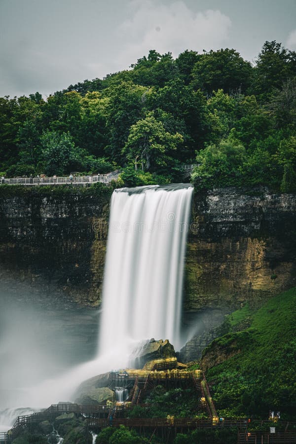 Vertical Mesmerizing View of a Gracefully Falling Waterfall on Cliffs ...