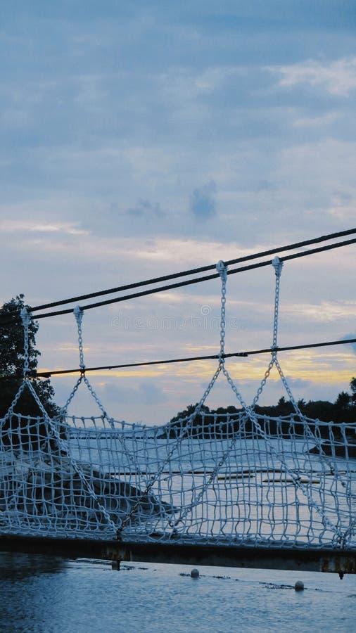 Vertical of a Metal Mesh Bridge with Chains Connecting the Net Captured ...
