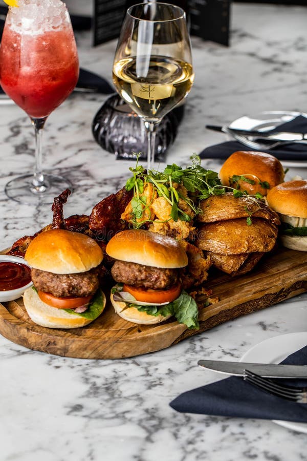 Vertical of Mini Burgers with Drinks Served in a Restaurant Stock Image ...