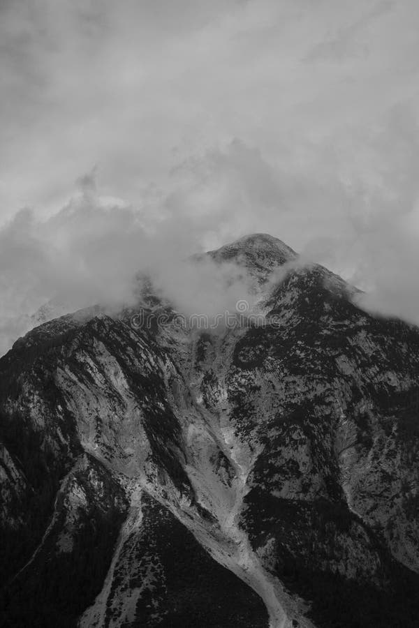 Vertical of a Mountain Range Covered with Snow and Clouds Shot in ...