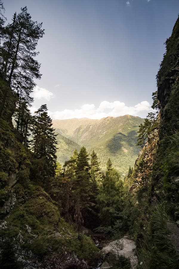 Vertical Mountain Ranges and Steep Cliffs in a Valley with Coniferous ...