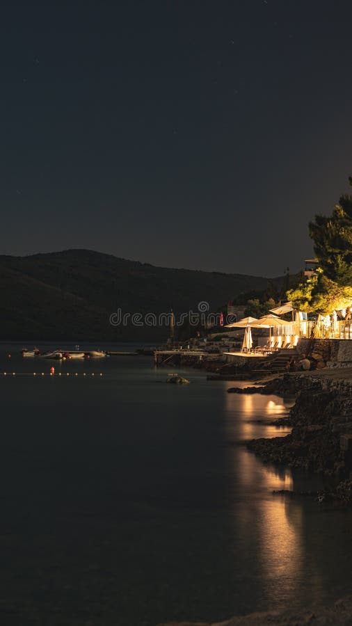 Vertical of Night Dubrovnik View with Water Reflecting Lights and Dark ...