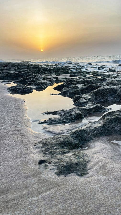 Vertical of Ocean Waves Approaching a Rocky Beach with Grey Sand ...