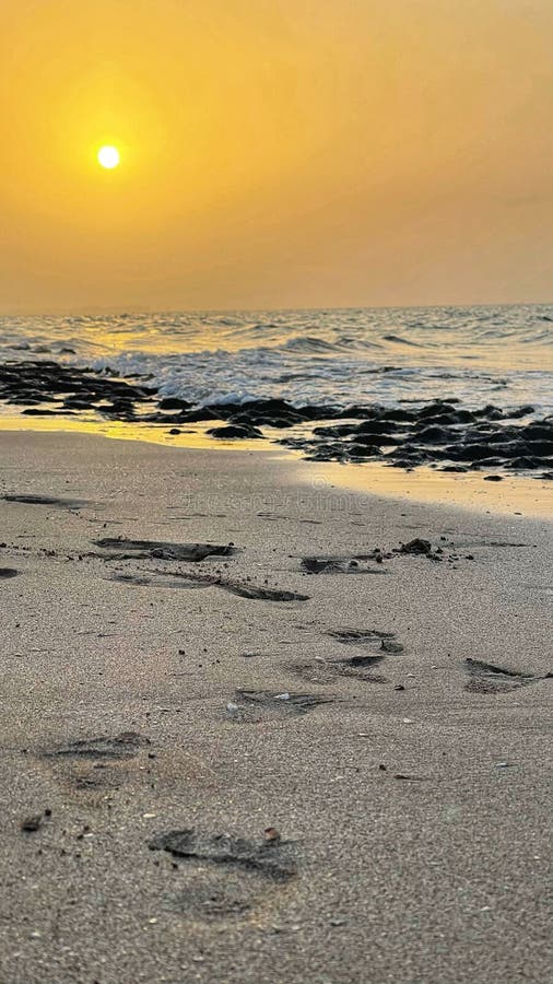 Vertical of Ocean Waves Approaching a Rocky Beach with Grey Sand ...