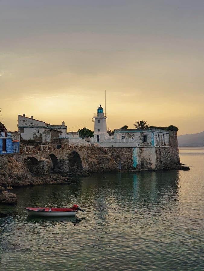 Vertical of an Old Lighthouse with a Seascape View at Sunset, Algeria ...