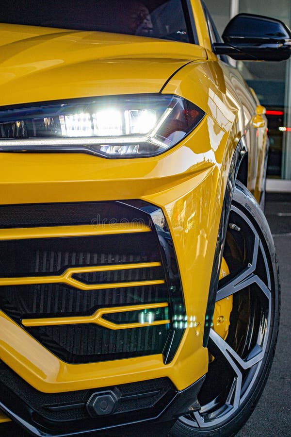 Vertical Partial View of a Yellow Lamborghini Urus with the Front Wheel ... Vertical Partial View of a Yellow Lamborghini Urus with the Front Wheel ...