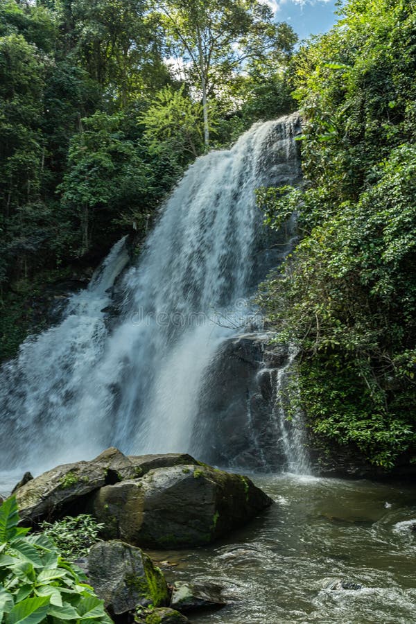Vertical Photo of the Water Falling from a Tall Waterfall with Rocks ...