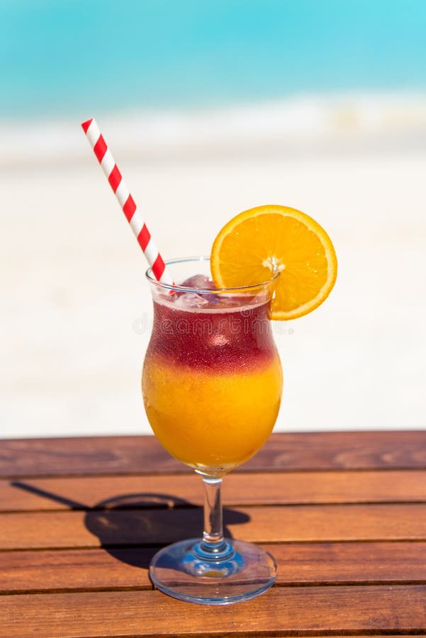 Vertical Photos Of Sex On The Beach Cocktail With Straw On Wooden Table