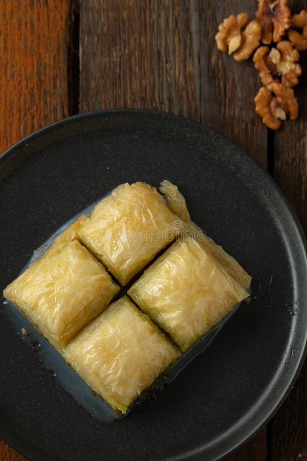 Vertical Picture of Baklava Cut in Cubes in a Plate and Walnuts on a ...