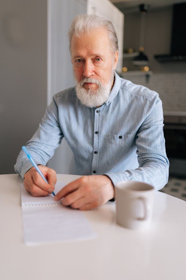 Vertical Portrait of Aged Gray-haired Man Writing Making Notes in ...